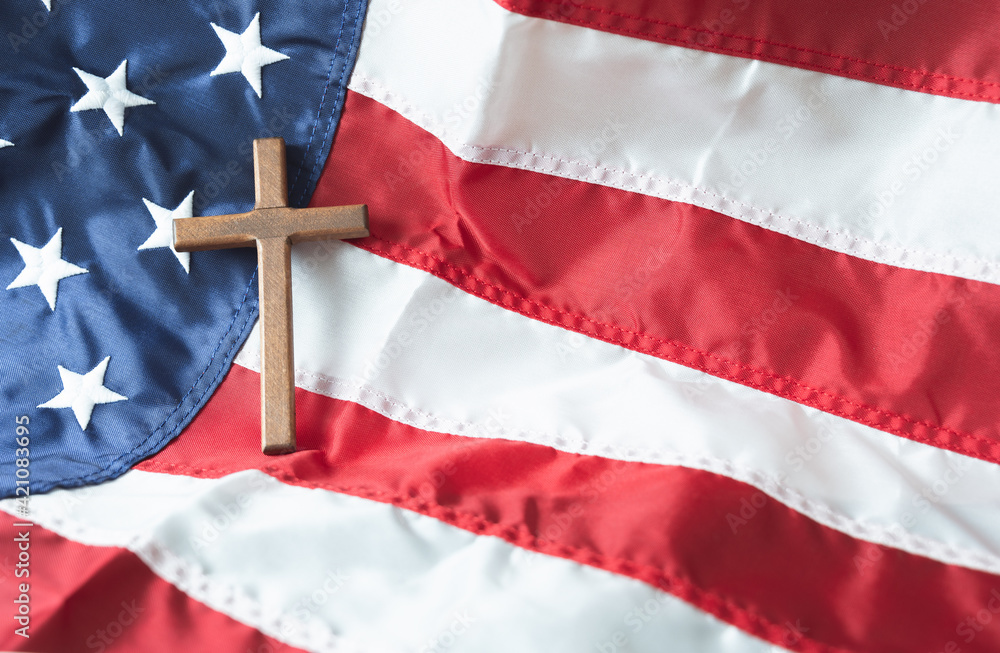 Religious right concept with Christian Wooden cross on American flag ...