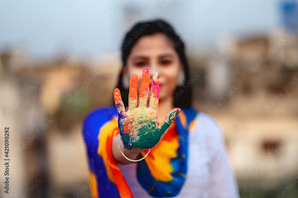 Colorful hands of happy Indian woman celebrating Holi with powder ...