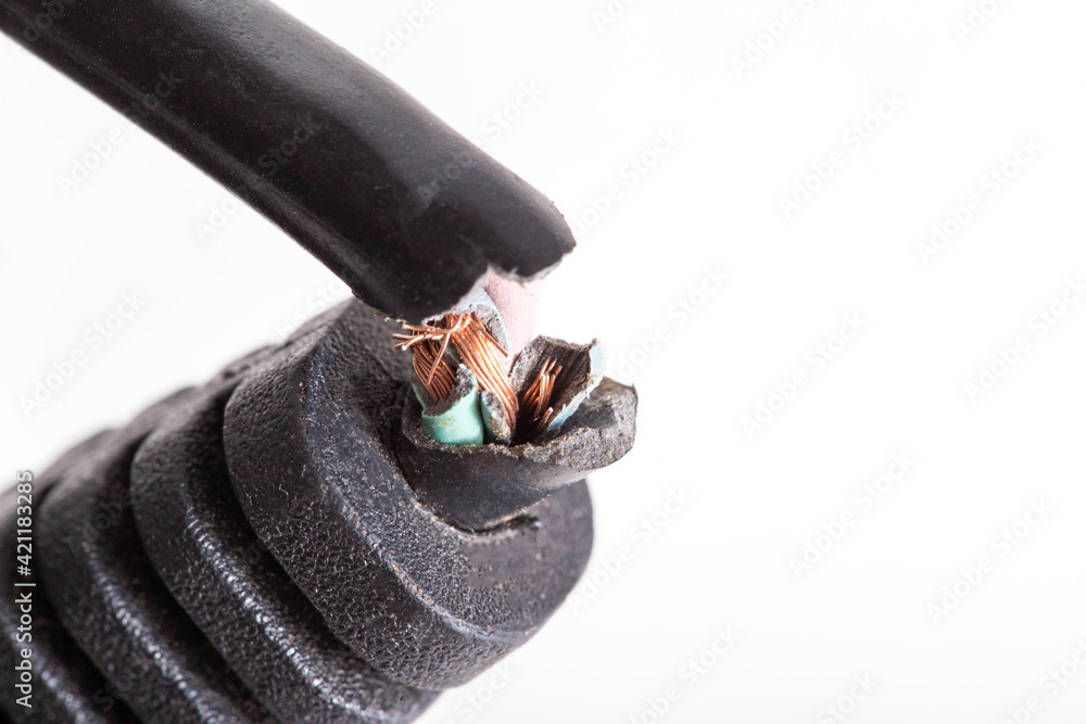 Broken electrical wire with a plug on a white background, isolate ...