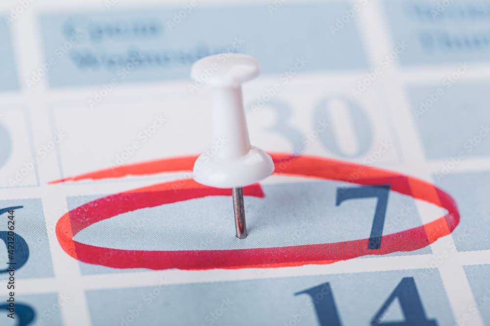 Calendar page for 2021, marked with an important date with a white pin ...