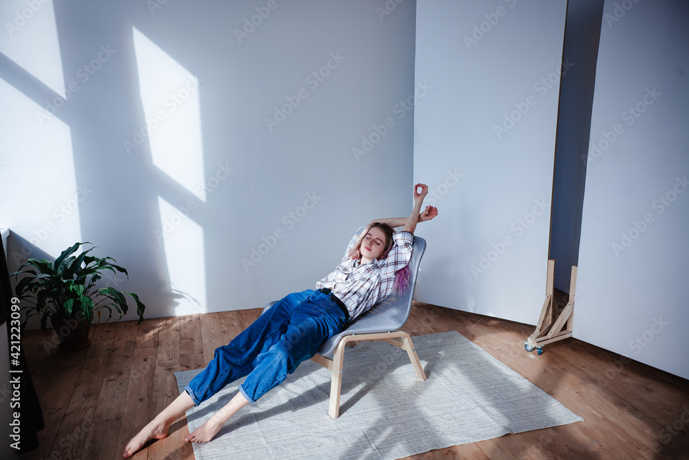 girl in jeans and shirt lying on a chair, minimalistic design Stock ...