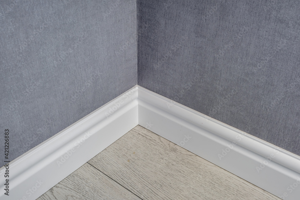 Detail of corner flooring with intricate crown molding and plinth ...
