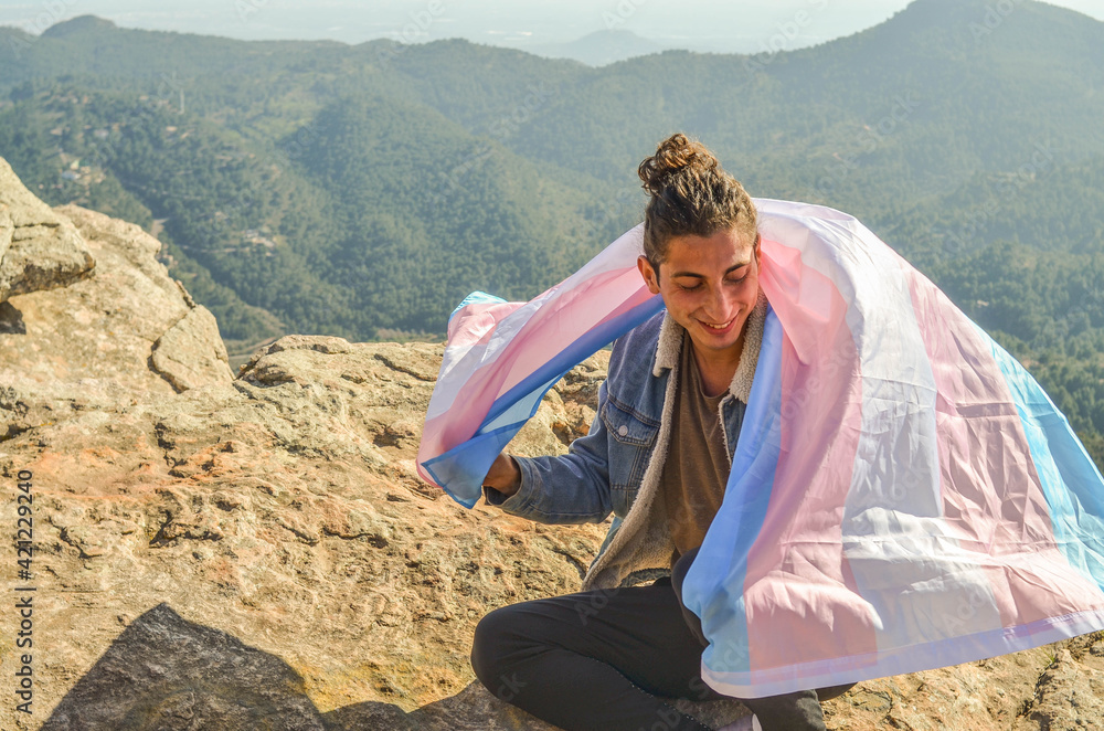 Cute Transgender Man Smiling Showing LGTB blue and pink Flag as Cape ...