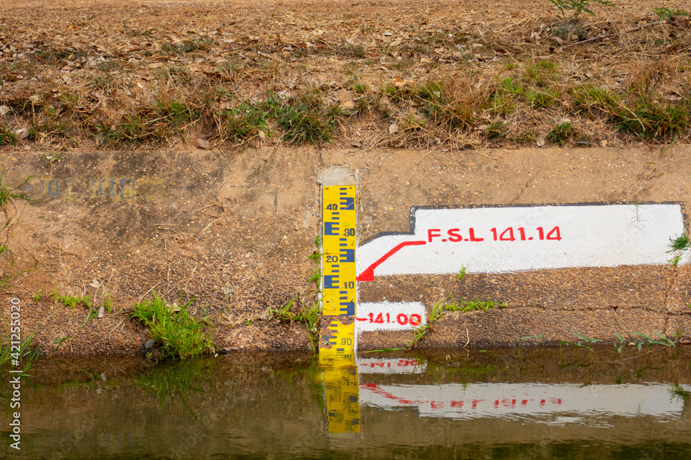 The water level measuring staff in the irrigation canal Stock Photo ...