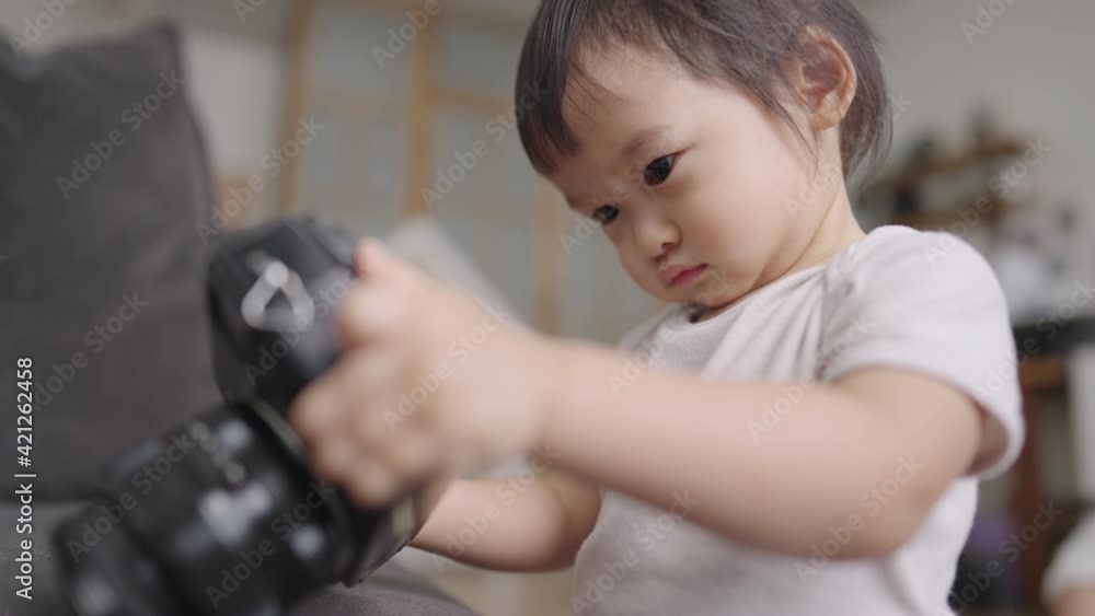 Happy adorable cute asian preschool girl in casual out holds camera and ...