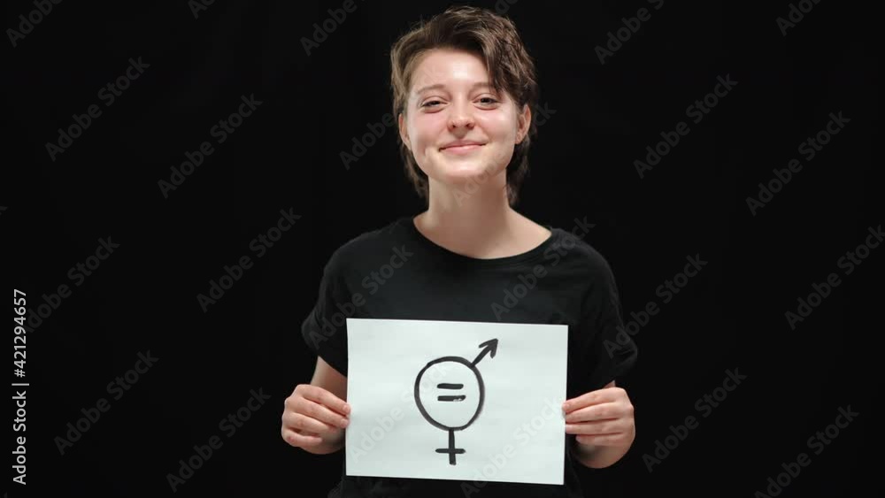 Smiling beautiful Caucasian young woman posing at black background ...