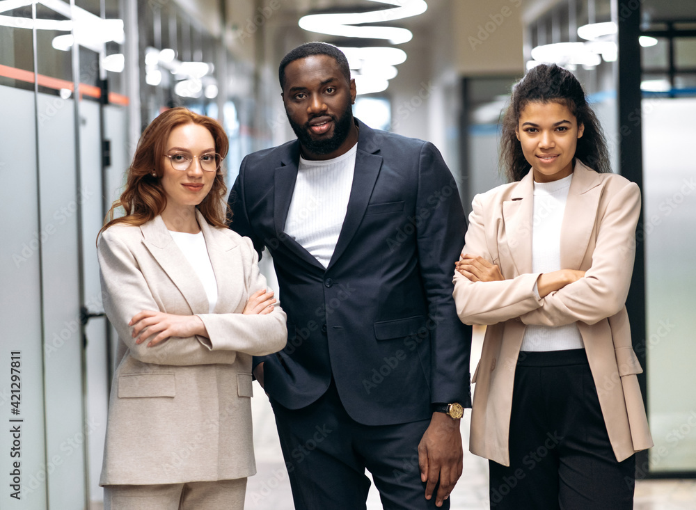 Influential business partners are confidently looking at the camera ...