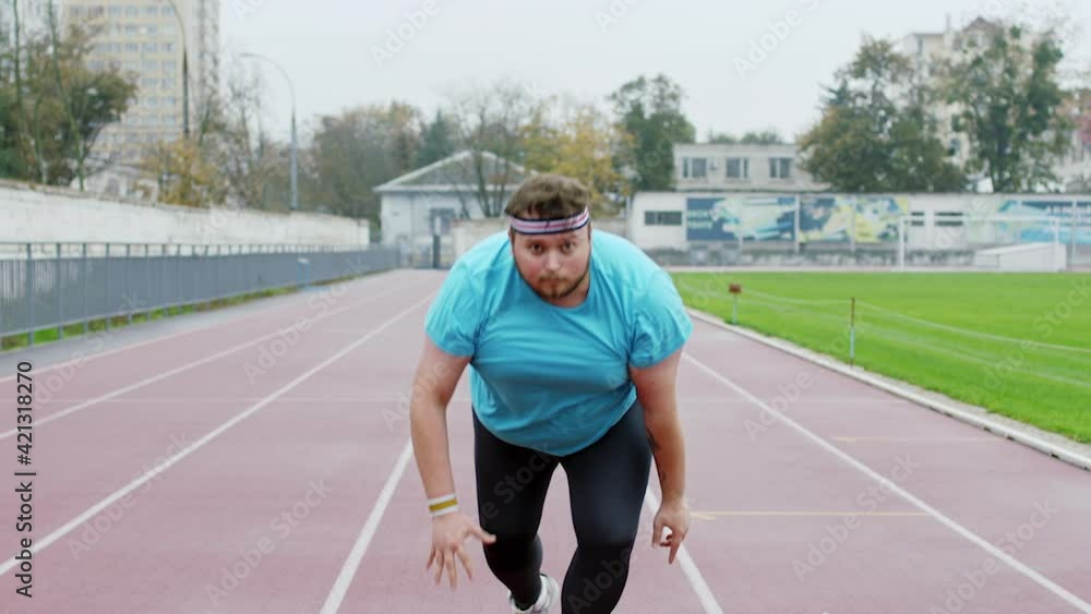 Healthy lifestyle concept obese man running fat in the stadium from the ...