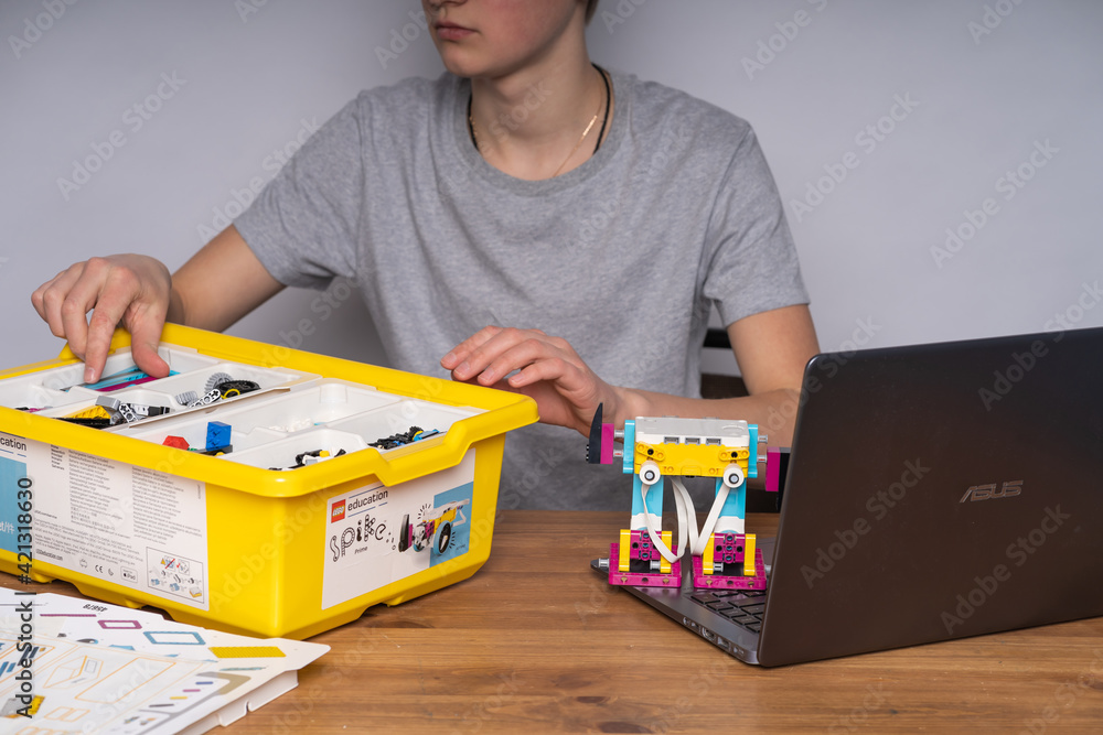 Minsk, Belarus. March, 2021. Teenagers collect and program the new Lego ...