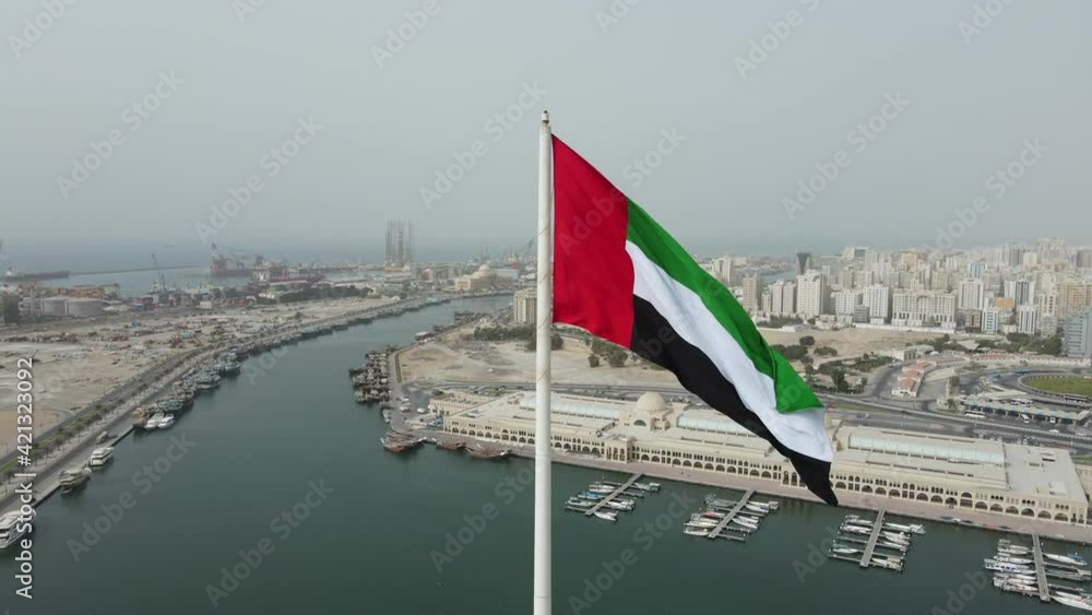 UAE FLAG: Drone camera circling around the flag of United Arab Emirates ...