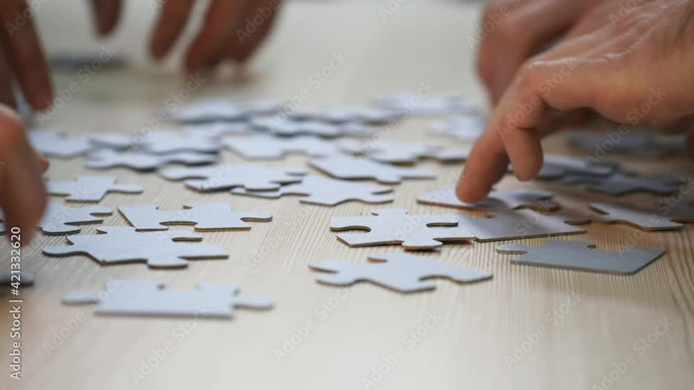 Vidéo Stock Teamwork. Group of people at table are putting together ...