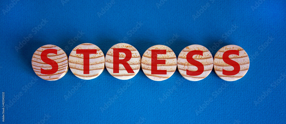 Stop stress and be health symbol. Wooden circles with the word 'stress ...