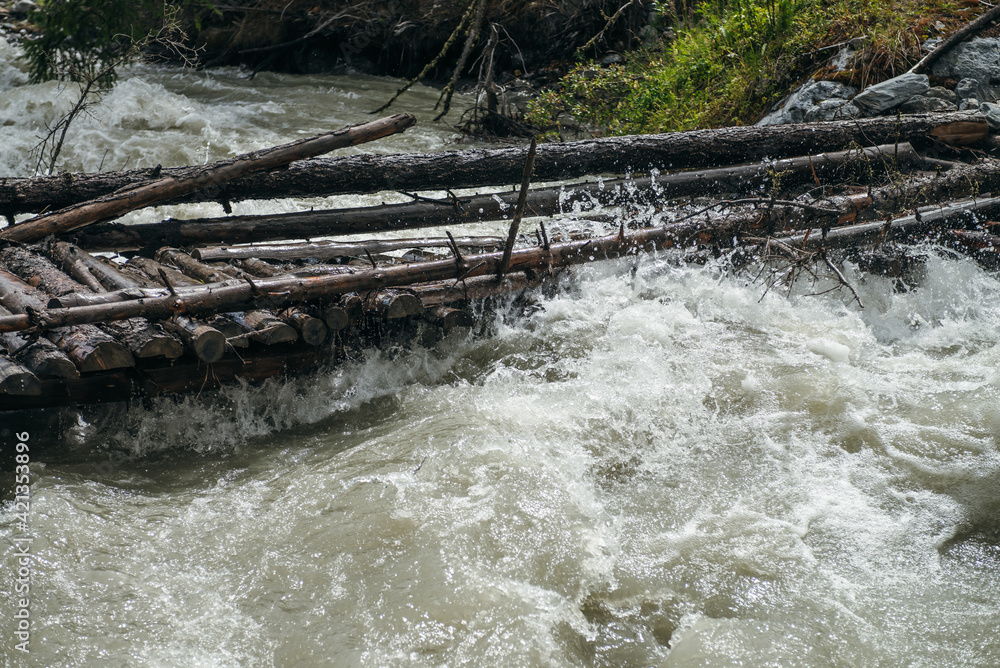 Fast turbulent river with broken bridge in water. Scenic mountain ...