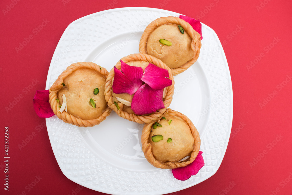 Popular Indian mithai or sweets known as chandrakal. round dumpling ...