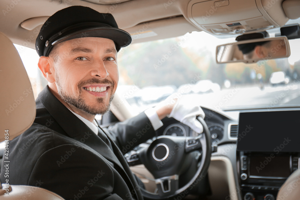 Handsome chauffeur driving luxury car Stock Photo | Adobe Stock