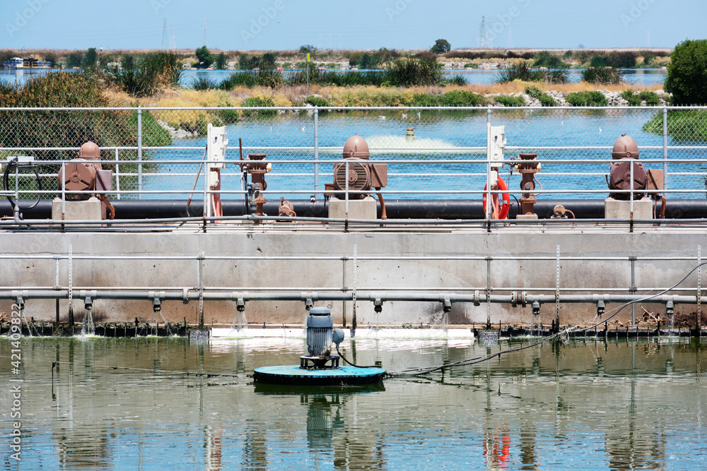 Small concrete dam separates the wastewater treatment facility ...