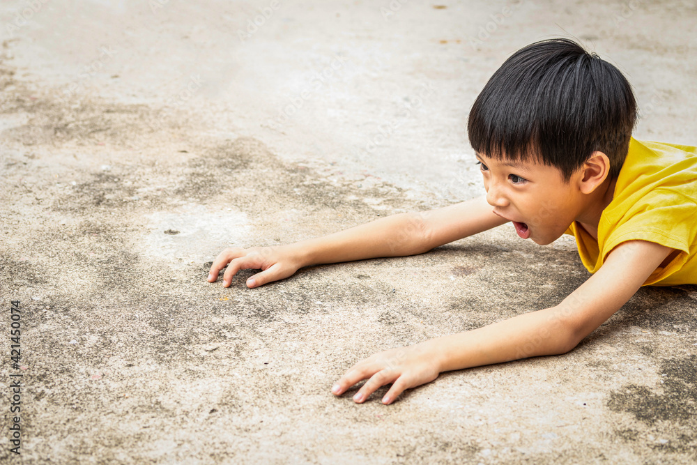 The boy falls to the cement floor. Making a very shocked face. The ...