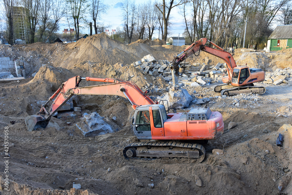 Excavator with hydraulic breaker hammer. Excavator on demolition the ...