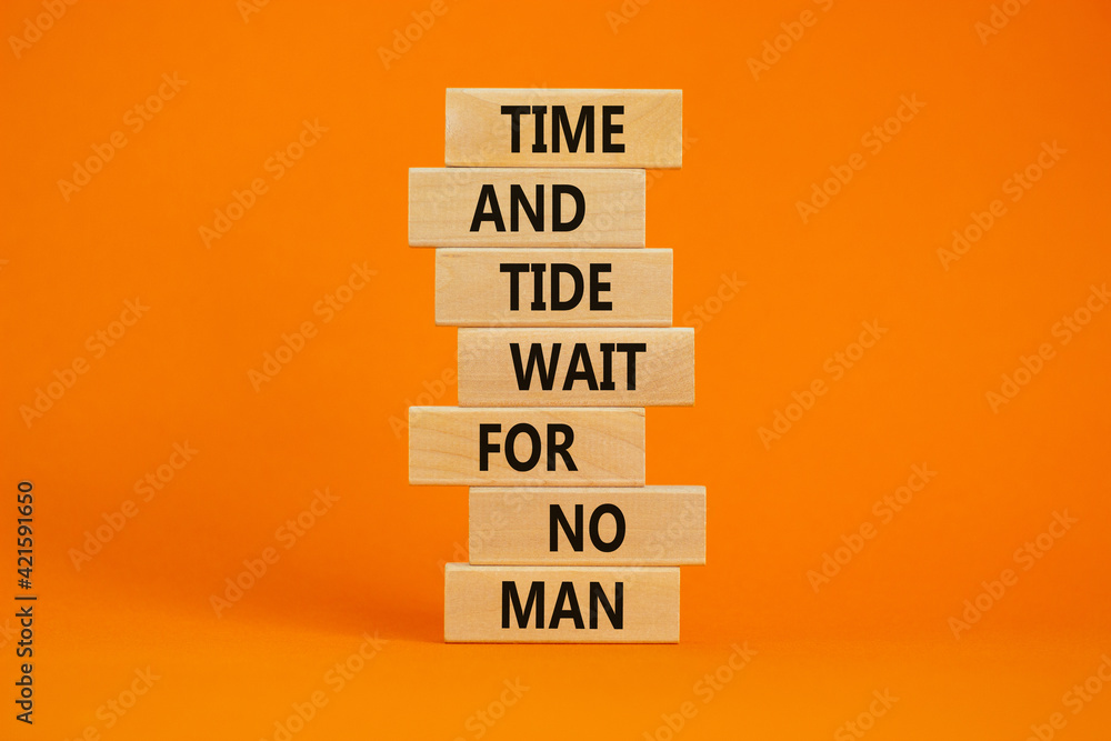 Time to action symbol. Wooden blocks with words time and tide wait for ...