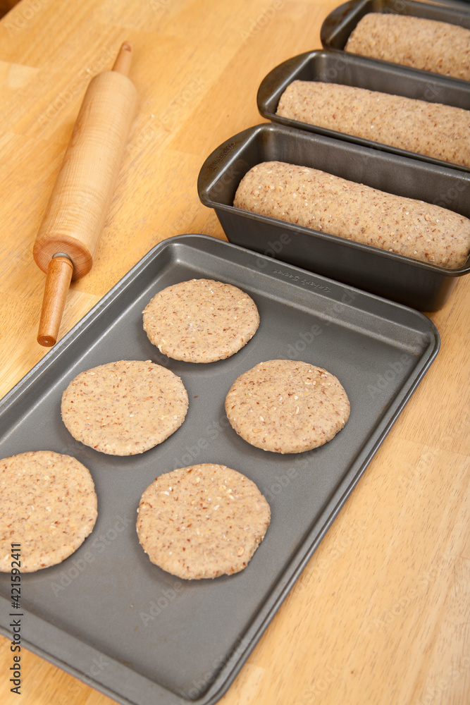 Multigrain bread dough formed into loaves and circles (to make ...