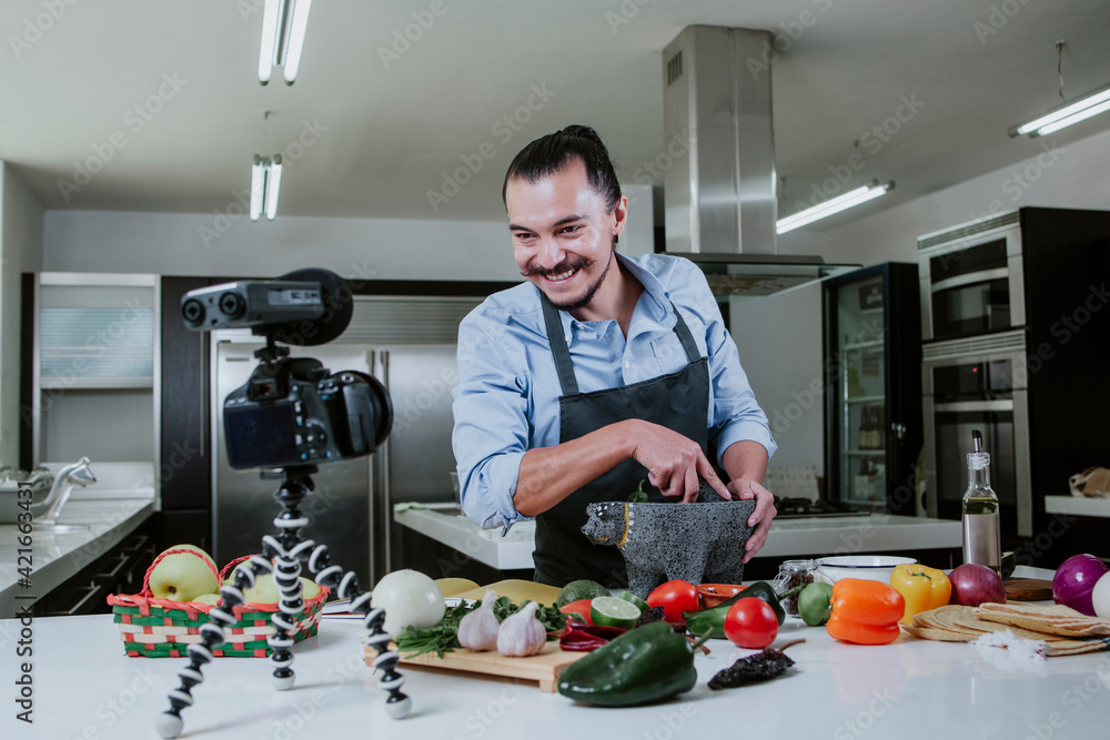 mexican man food blogger preparing mexican sauce, cooking and culinary ...