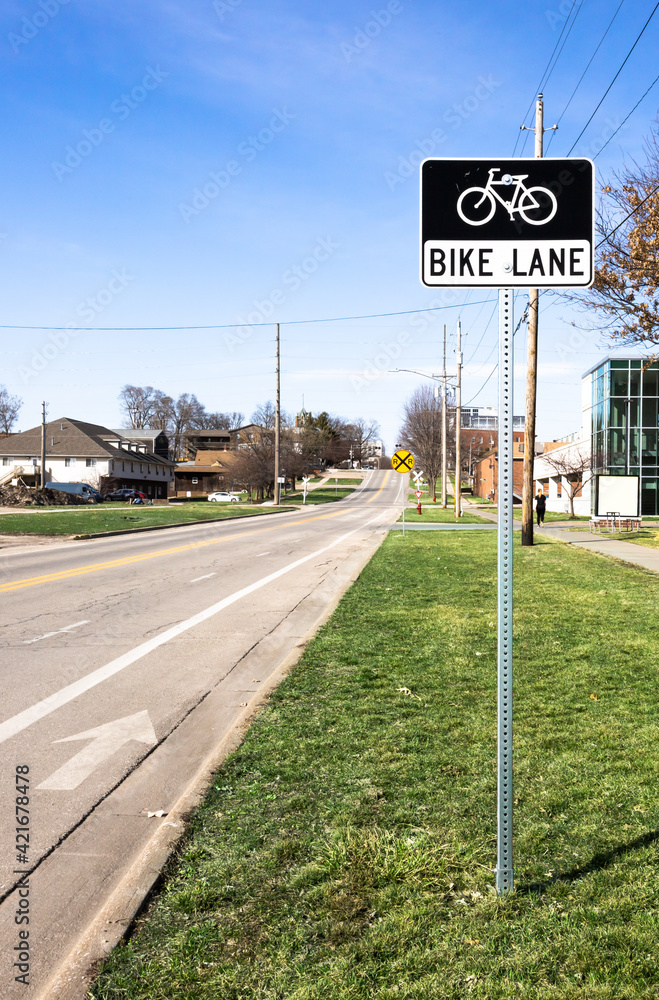 Bike lane road sign on green grass pathway, safety for bicycle with ...