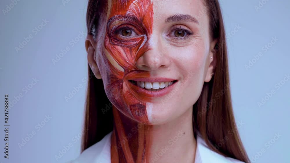 Young woman with half of face with muscles structure under skin. Model ...
