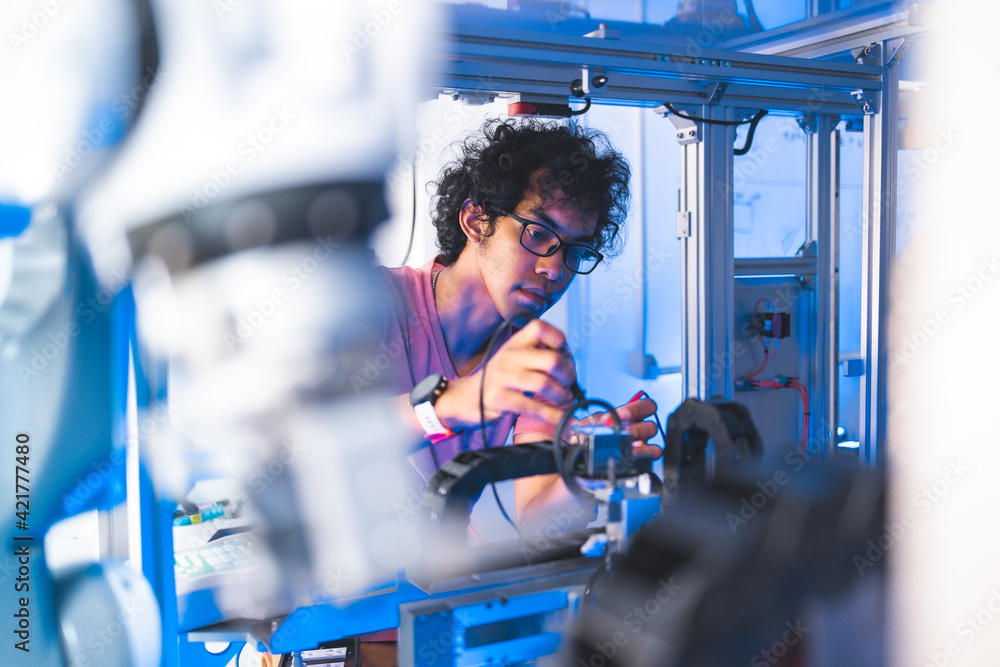 Male Engineers Maintenance Robot Arm at Lab. he are in a High Tech ...