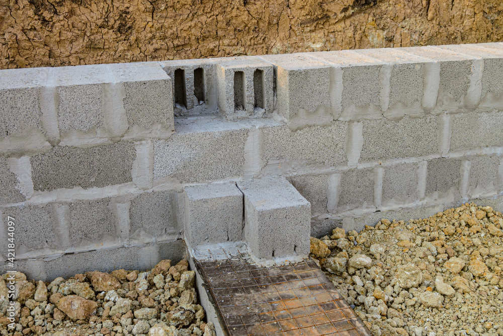 Construction of stone walls of a building from hollow concrete blocks ...