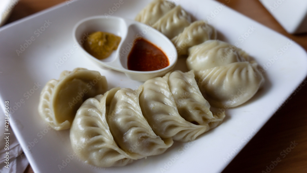 Typical boiled chicken momo with spicy and peanut sauces from Nepal ...