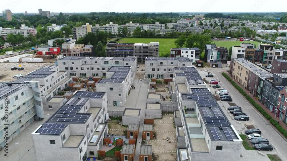 Aerial bird view flying backwards over unfinished new housing project ...