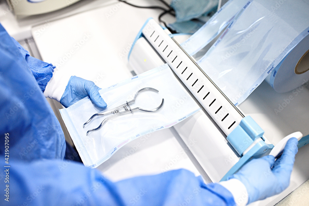 Sterilizing medical instruments in autoclave. Dental office.Close up ...