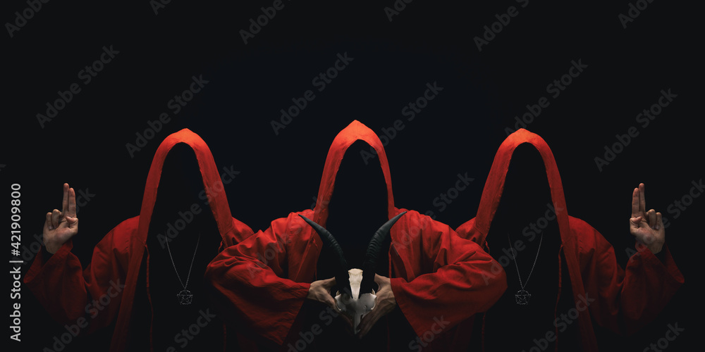 Mystery people in a red hooded cloaks in the dark. Hiding face in ...