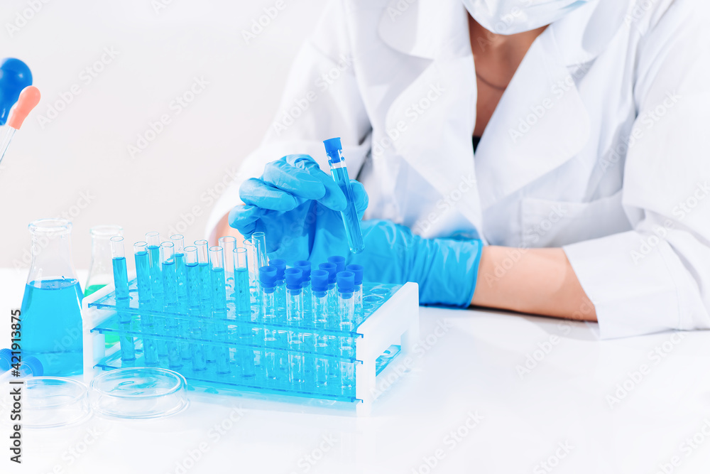 Development of new vaccines.hand of scientist holding flask with lab ...