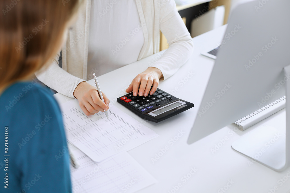 Accountant checking financial statement or counting by calculator ...