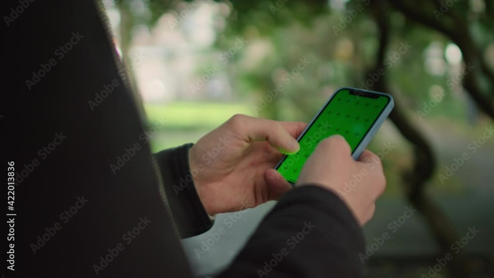 Close up hands man holding phone with vertical green screen on park background Stock-Video ...