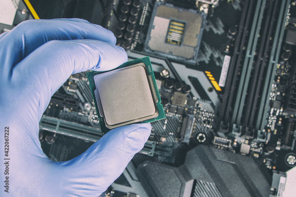 Plug in CPU microprocessor to motherboard socket. Technological ...