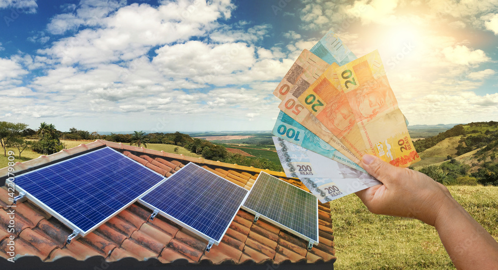 Solar Energy Economy, holding Brazilian money in front of the ...