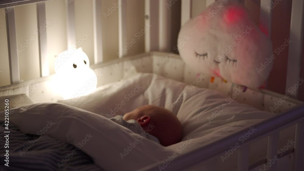 newborn baby boy sleeping in bed in the evening, 3-week-old infant in ...
