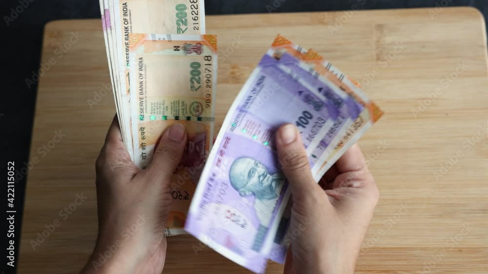 Counting Indian currency Rupee , hand giving Indian money 100, 200 ...