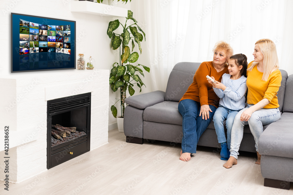 little girl mother and grandmother with remote control together while ...