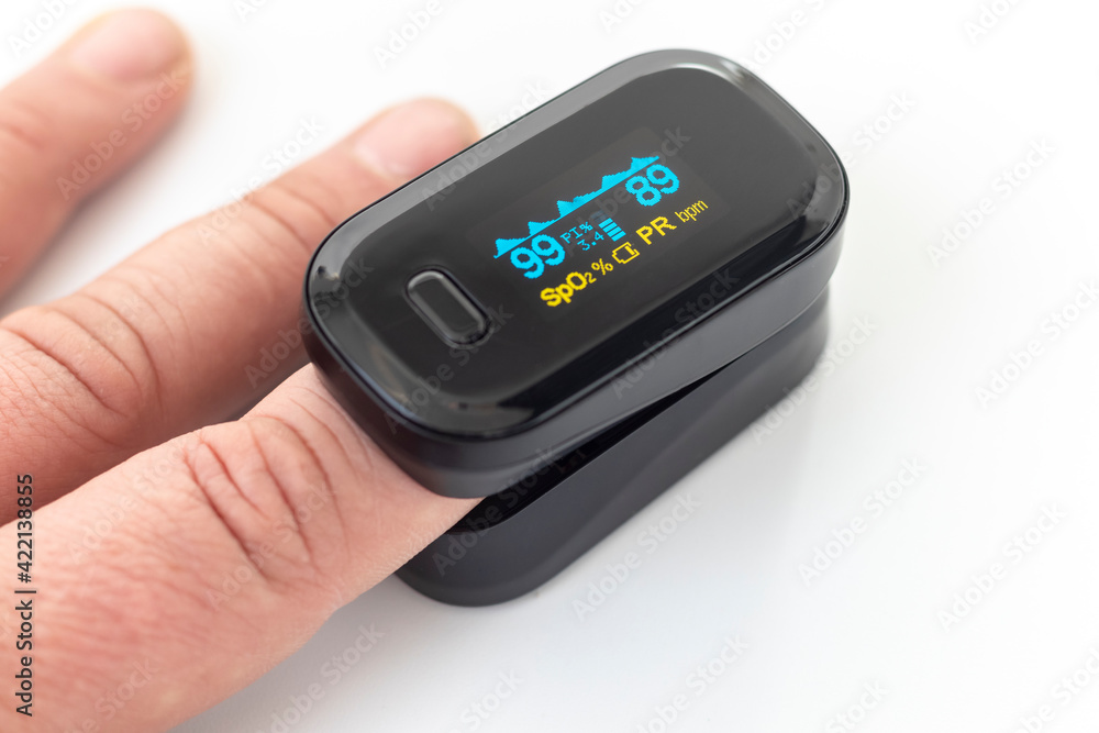 Portable black pulse oximeter on a white background. Monitoring the ...