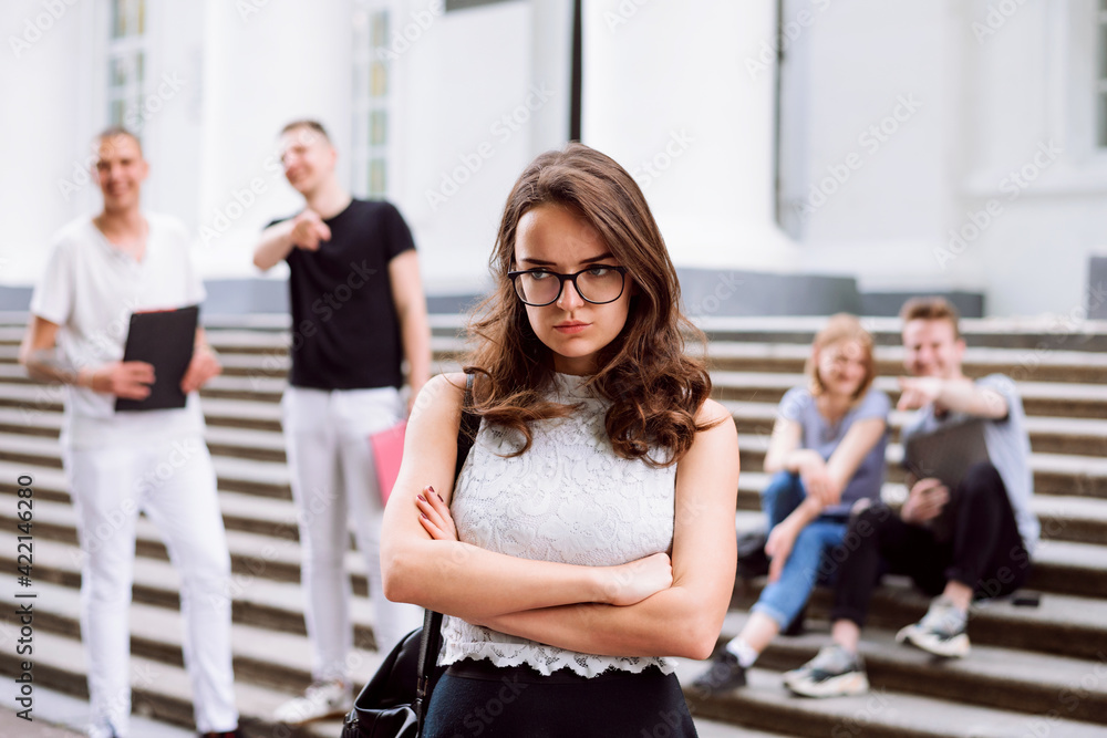 Poster Angry and upset college girl standing with her hands crossed ...