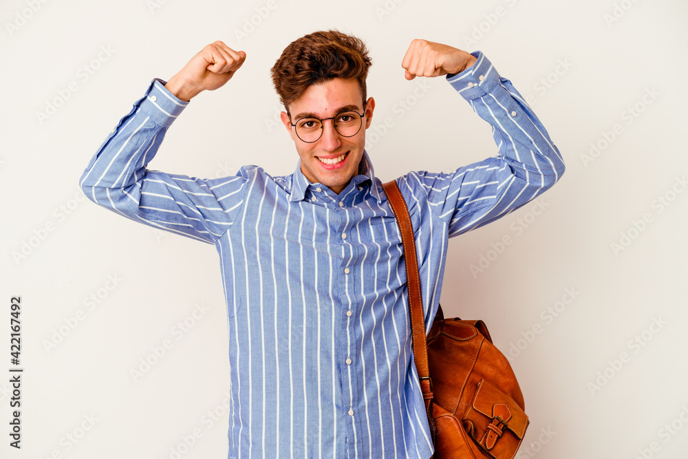 Young student man isolated on white background showing strength gesture ...