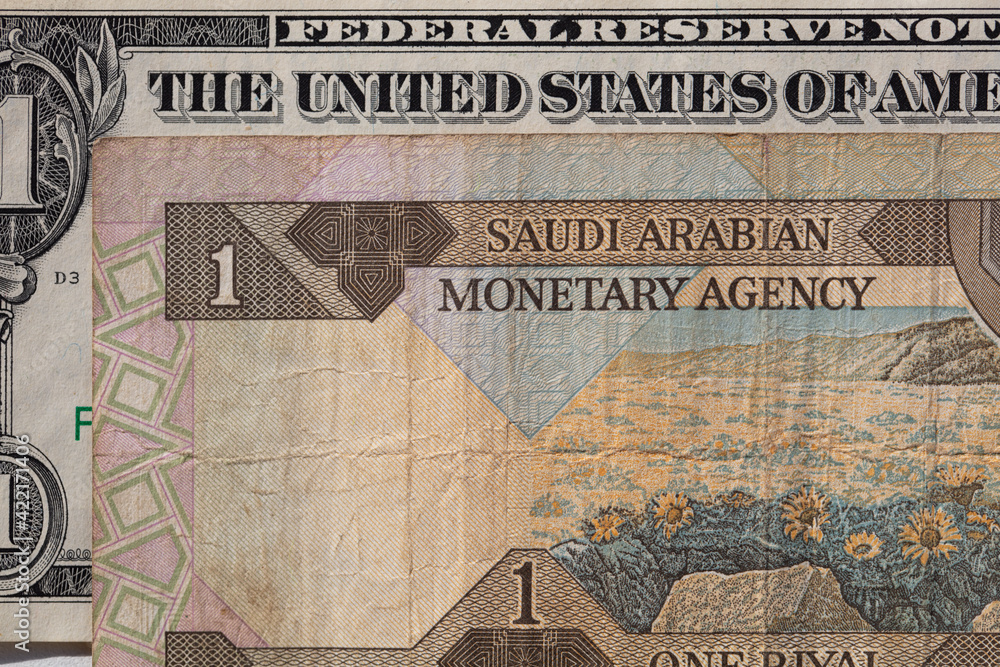 old one riyal of Saudi Arabia and 1 US dollar banknotes Stock Photo ...