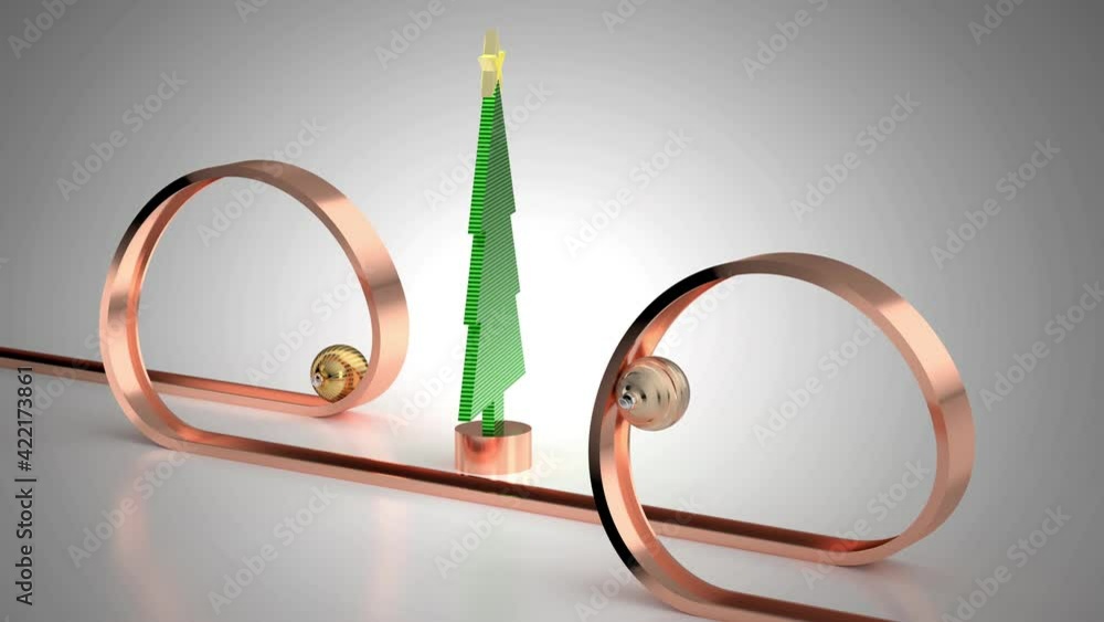 Christmas baubles rolling on a serpentine and rotating tree with a star ...