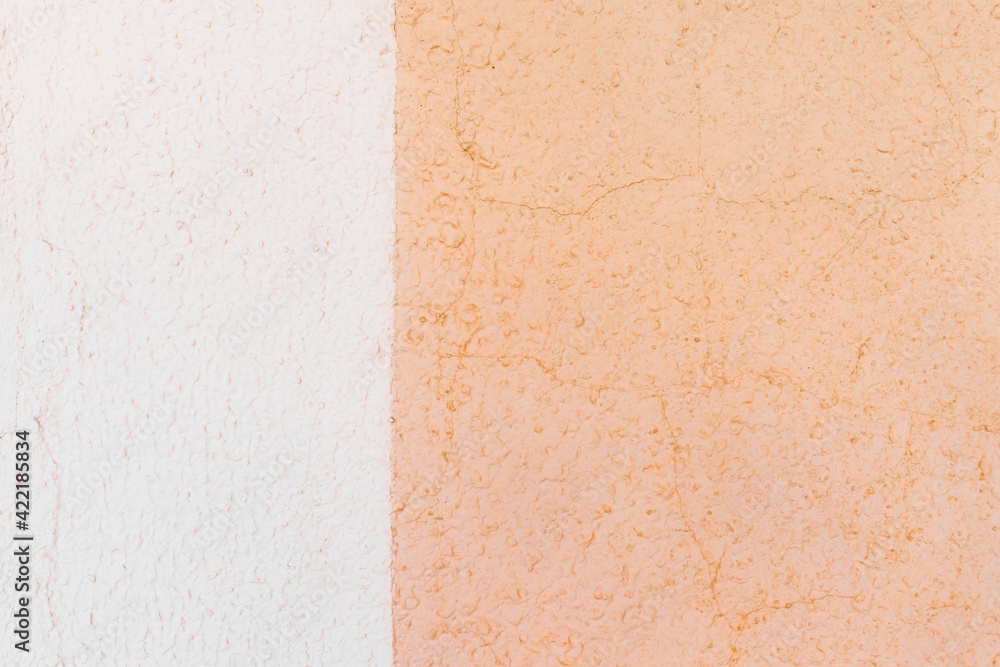 Two colors wall: white plaster and light orange surface with small ...