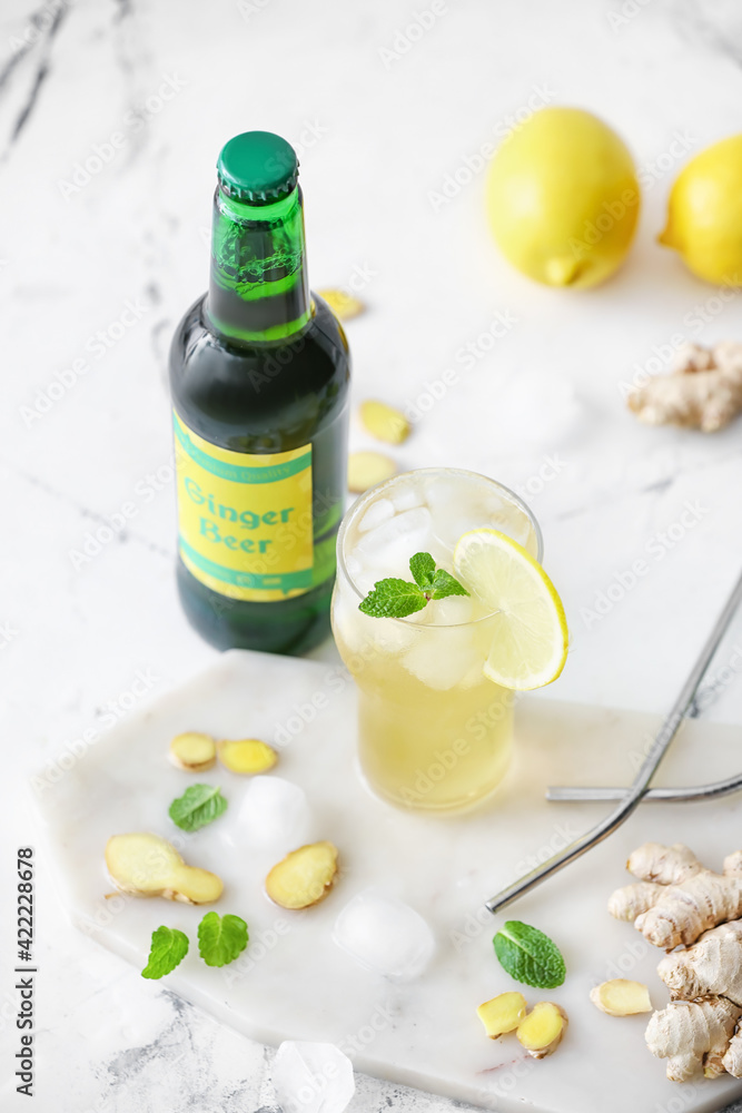 Bottle and glass of fresh ginger beer on light background Stock Photo ...