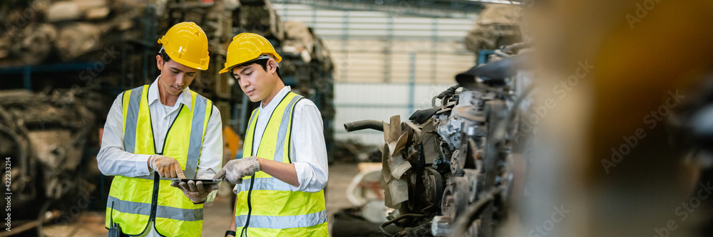 Teamwork engineers, Worker wear uniform and helmet talk and using tablet for work in warehouse ...