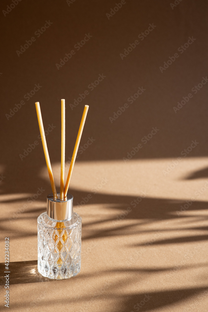 Aromatic reed air freshener on brown background hard shadow ...